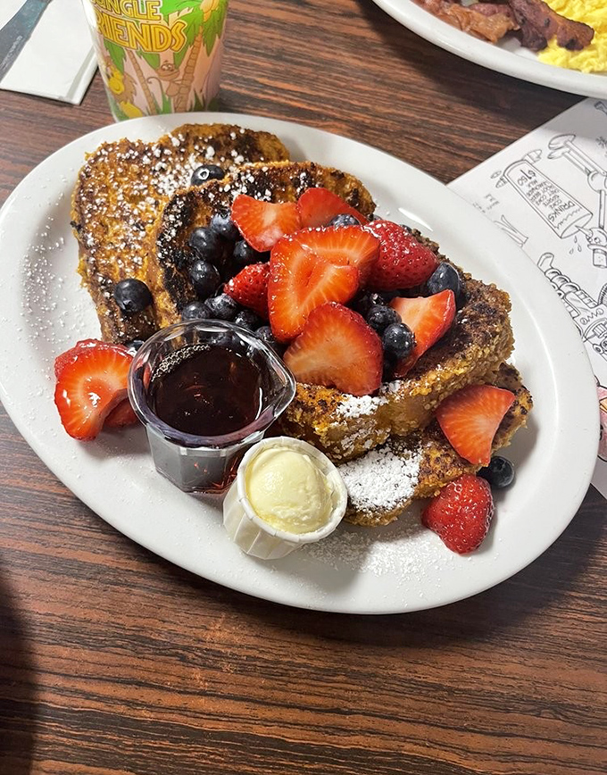 French toast that's had a proper introduction to fresh berries, maple syrup, and powdered sugar – a breakfast love triangle that works.