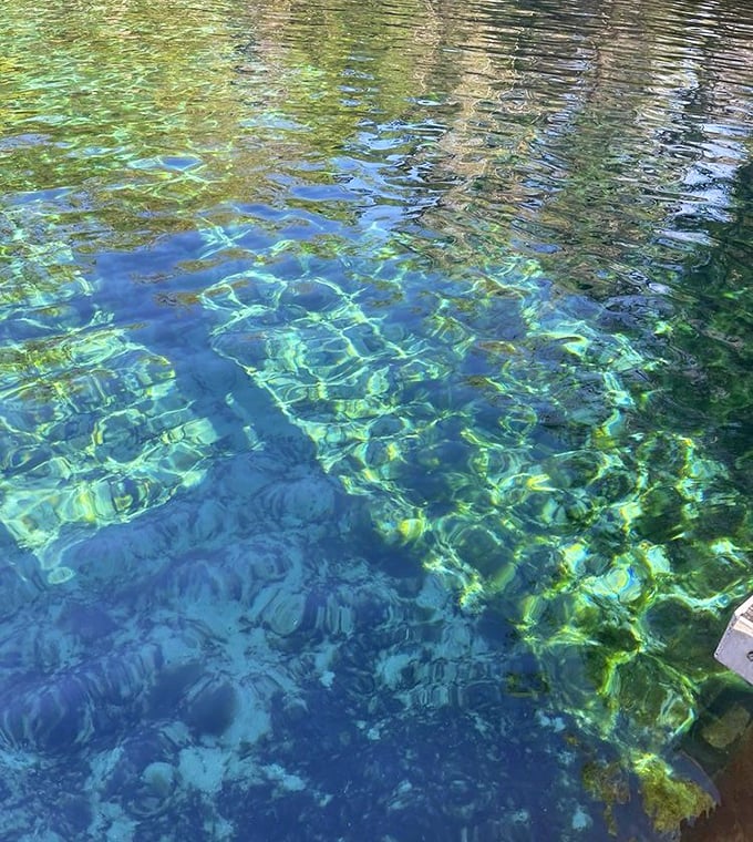 Mother Nature's stained glass window – sunlight dancing through water so clear you'd swear someone forgot to fill the pool.