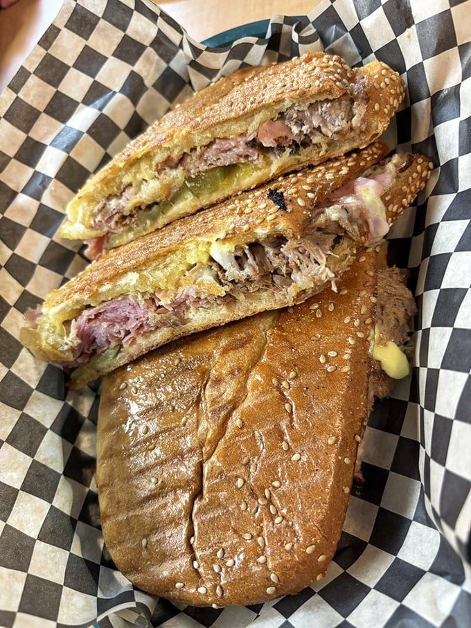 The Cuban sandwich, sliced to reveal its glorious layers. Like a delicious geological cross-section where each stratum tells a tale of flavor.