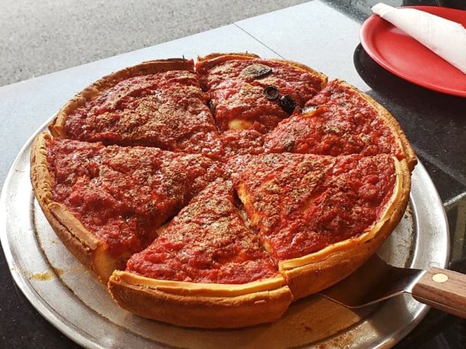 Chicago deep dish in its natural habitat—a golden-brown fortress of crust protecting a treasure of sauce and cheese worth traveling for. 