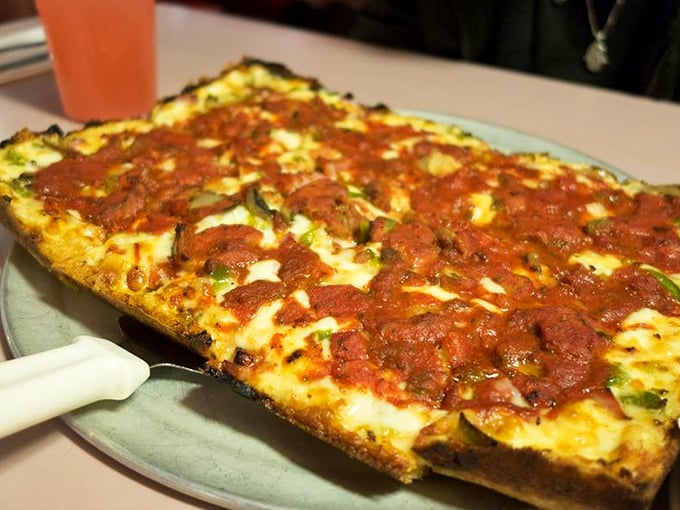The rectangular masterpiece that put Detroit on the pizza map. That caramelized cheese edge is worth fighting over—and you will.