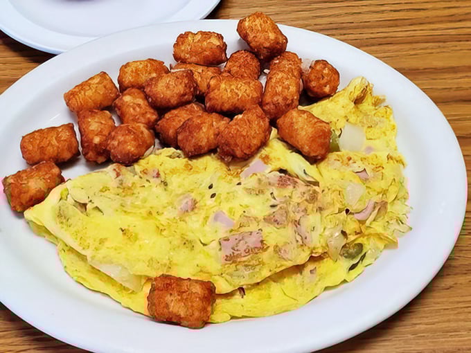 This omelet-hash brown combo isn't just breakfast, it's edible therapy – golden potatoes crisped to perfection alongside eggs that practically glow with goodness.