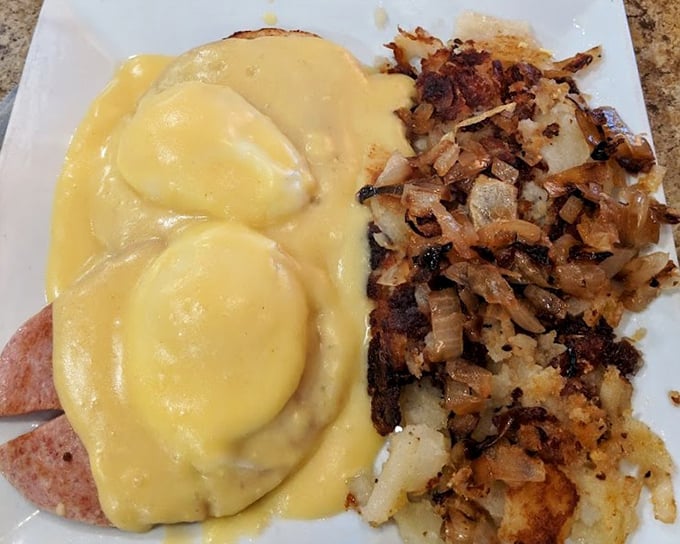 Eggs Benedict done right – perfectly poached eggs draped in hollandaise that's rich enough to have its own investment portfolio, with crispy home fries playing backup.