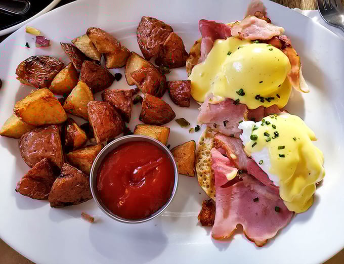 Eggs Benedict reimagined – those poached eggs look like they're wearing little hollandaise jackets to a fancy ham party.