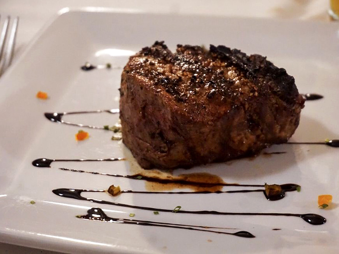 Behold the filet mignon in its natural habitat – perfectly seared, expertly seasoned, and ready to make your taste buds stand at attention.