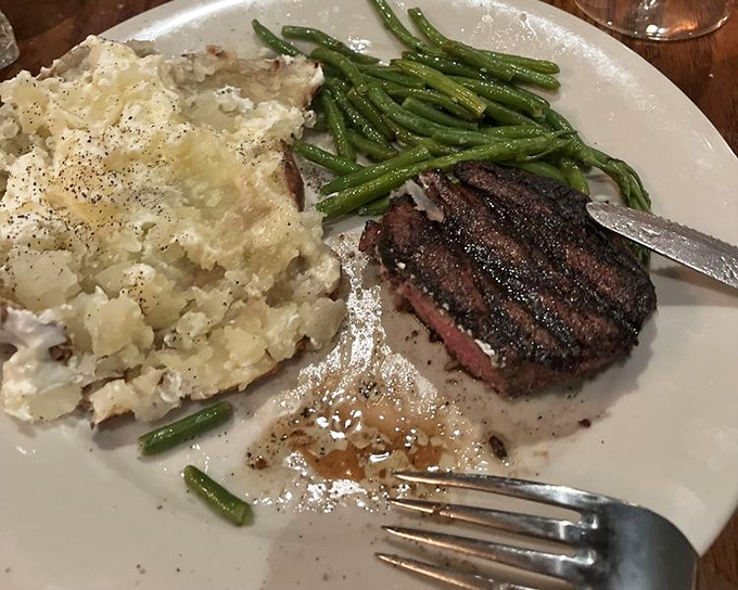 This filet mignon doesn't need fancy garnishes to impress—just a perfect sear, seasoned crust, and that loaded baked potato sidekick stealing part of the show.