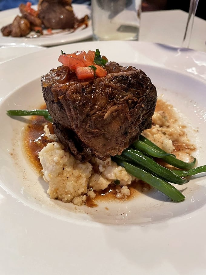 This isn't just steak—it's a monument to carnivorous pleasure, perfectly seared and resting on a cloud of mashed potatoes like a meaty throne.