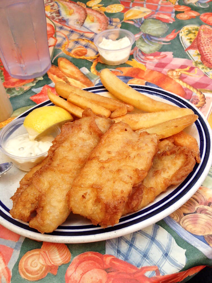 Fish and chips that would make a British pub jealous—golden, crispy batter protecting flaky white fish that practically high-fives your taste buds.