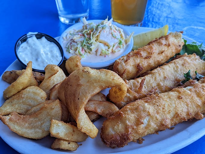 Golden-battered fish and chips that shatter with each bite, served with the kind of coleslaw that makes you rethink your relationship with cabbage.