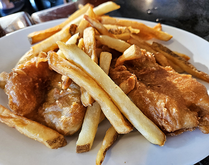 Fish and chips done right—crispy, golden batter protecting flaky white fish. The kind of comfort food that makes you want to hug the chef.