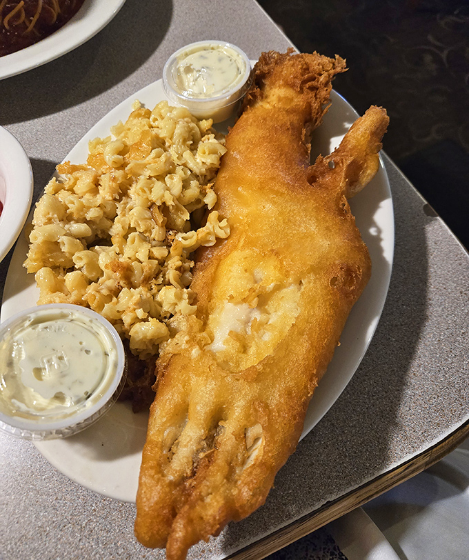 This isn't just fish—it's golden-armored treasure from the deep, accompanied by mac and cheese that clearly didn't come from a box.