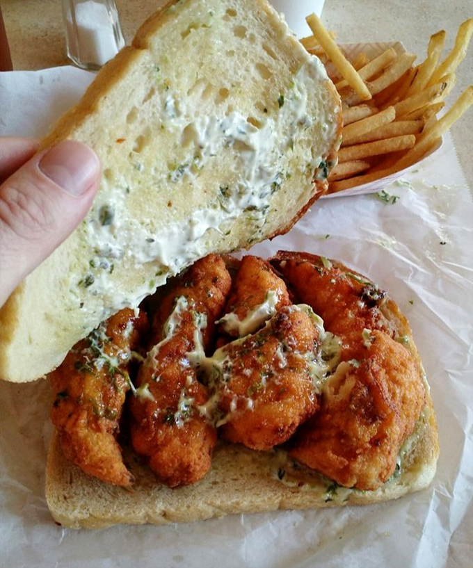 The fried fish sandwich arrives like Neptune's gift—crispy, golden treasures from the deep paired with classic fries.