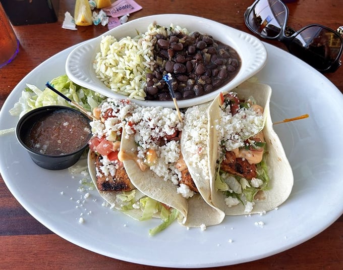These fish tacos aren't just a meal, they're a vacation on a plate. The black beans and rice bring a Caribbean rhythm that makes your taste buds want to dance.
