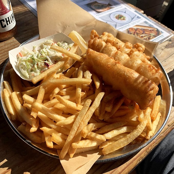 Fish and chips that would make a British pub jealous. That golden batter shatters with a satisfying crunch that echoes across the pier.