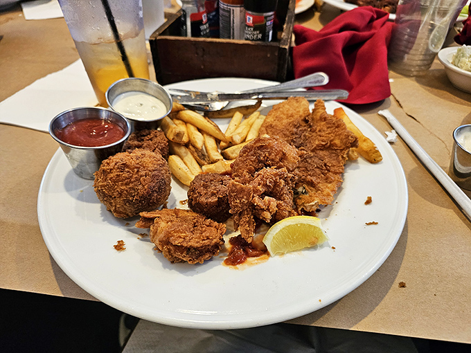 Crispy golden perfection meets the ocean's bounty. This seafood platter doesn't just satisfy hunger—it creates memories that linger long after the last bite.