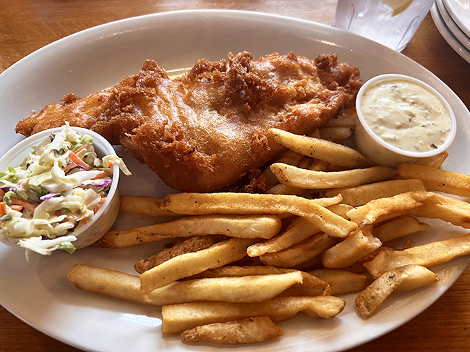Fish and chips that puts the "crisp" in crispy. Golden-battered perfection flanked by fries and coleslaw—the holy trinity of comfort food.