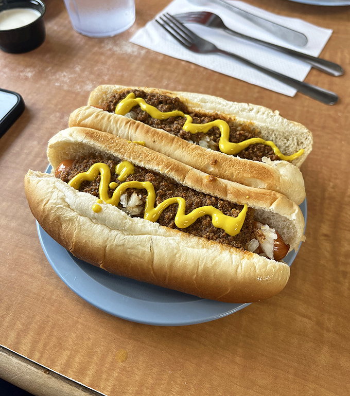Two chili dogs with that perfect zigzag of mustard—the universal symbol for "you're about to have a really good time."