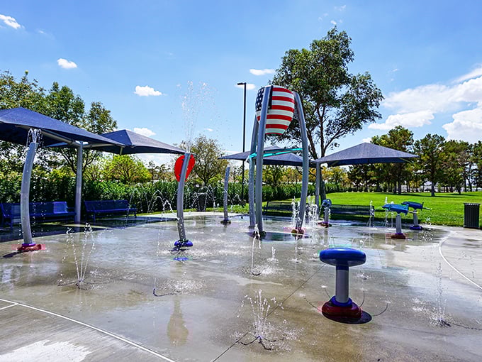 Freedom Park's splash pad—where desert kids discover water doesn't just come from faucets and adults remember what it's like to laugh without checking emails.