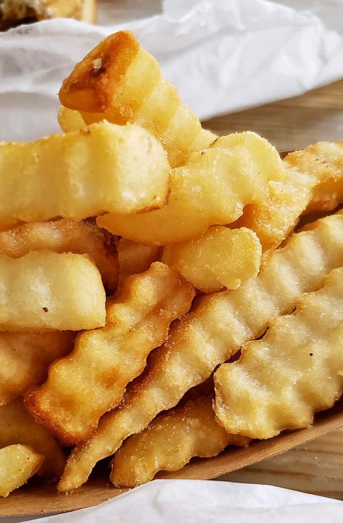 These aren't just french fries; they're golden potato perfection that somehow manages to be both crispy and fluffy in all the right places.