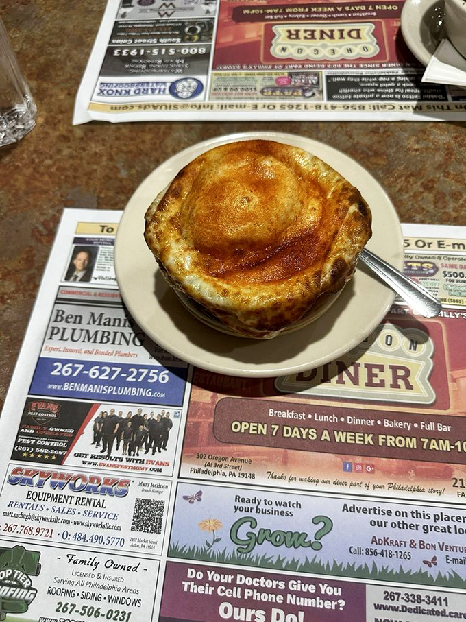 This French onion soup isn't just a dish—it's a commitment to excellence under a cathedral of perfectly browned cheese.