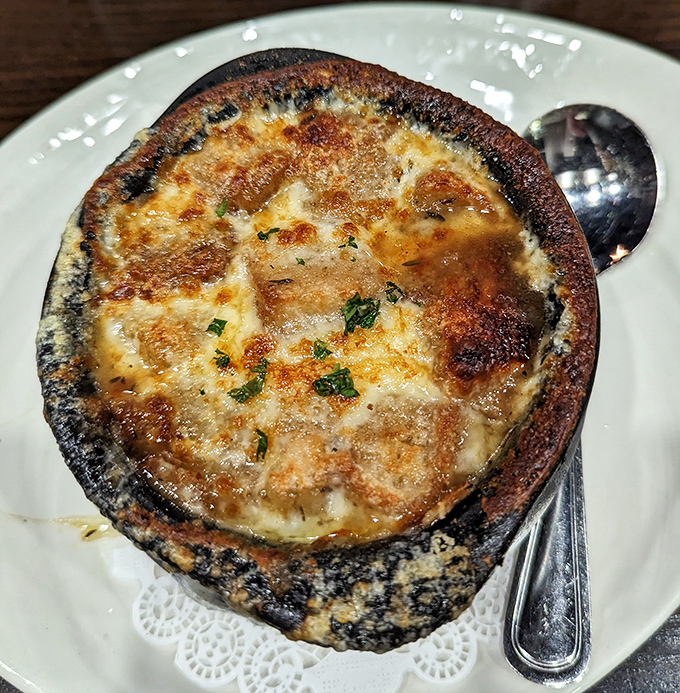 This isn't just French onion soup – it's a cheese-crowned miracle in a crock that would make Julia Child slow-clap in approval.