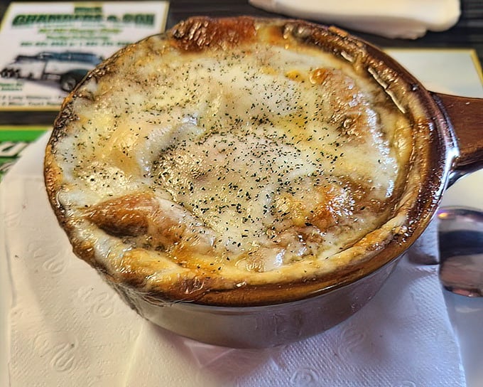 This isn't just French onion soup—it's a bubbling cauldron of comfort topped with a cheese lid that deserves its own zip code.