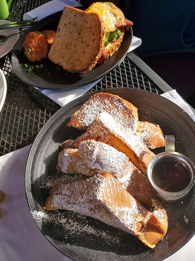 French toast that's dressed for success—powdered sugar dusted like fresh snow over golden bread that's crisp outside, custardy inside. Breakfast royalty.