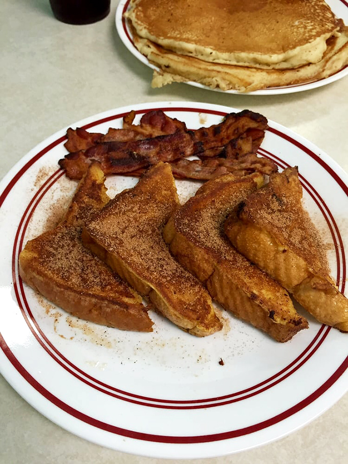 This isn't just French toast—it's bread that took a spa day in vanilla custard before getting the perfect golden tan. The cinnamon sugar is just showing off.