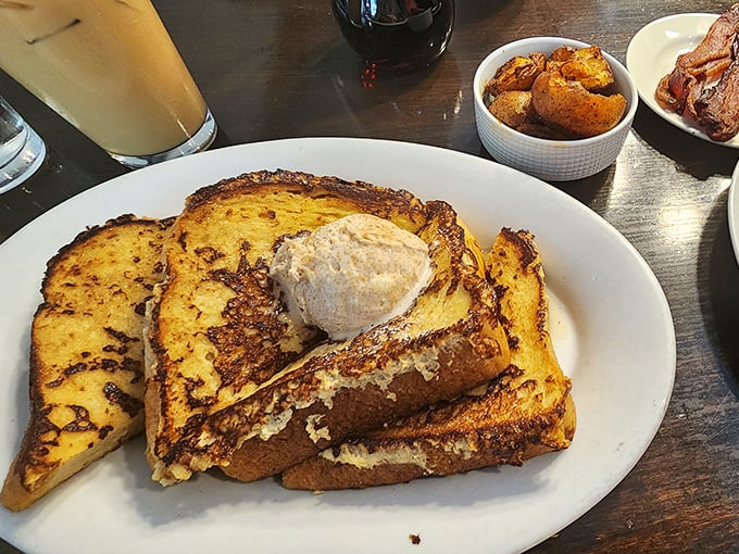 French toast that's achieved that mythical balance—crispy edges, custardy center, and a dollop of butter slowly creating rivers of melted goodness.