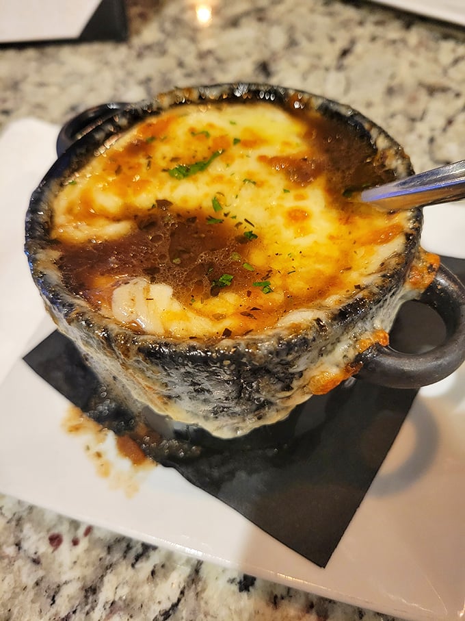 This isn't just French onion soup—it's a bubbling cauldron of cheese-capped comfort that would make Julia Child weep with joy.