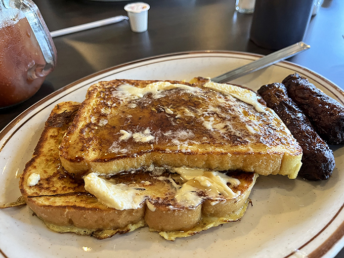 French toast that's achieved the impossible dream: crispy edges, custardy centers, and enough butter to make your cardiologist wince approvingly.