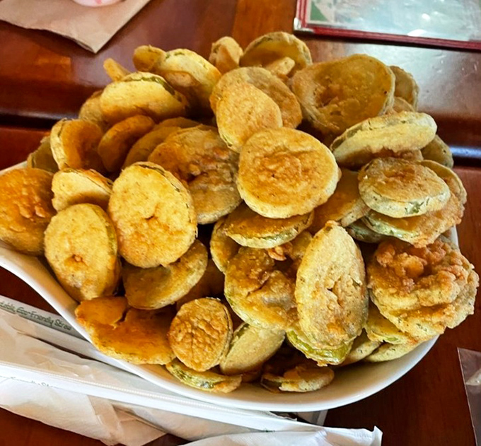 Golden-fried pickle chips stacked higher than your vacation reading list – a crunchy, tangy prelude to seafood bliss.