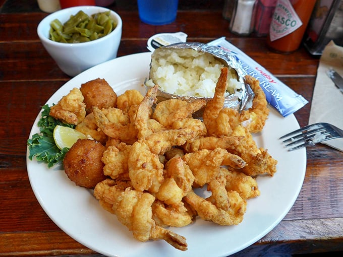A plate of perfectly fried shrimp alongside a baked potato that's dressed for success. This isn't just dinner—it's coastal Georgia on a plate.