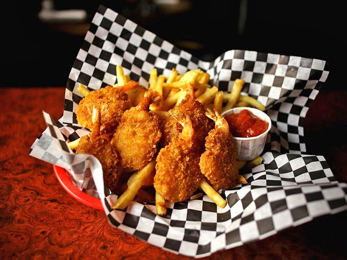 Golden-battered butterfly shrimp nestled among crispy fries – the kind of comfort food that makes you wonder why anyone bothered inventing molecular gastronomy.