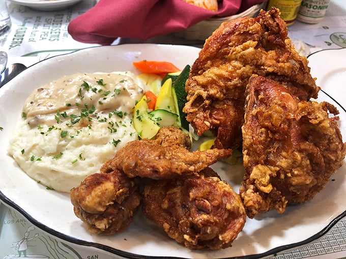 Golden, crackling perfection – this fried chicken might be the best-kept secret on I-5, hiding in plain sight at a place famous for something entirely different.