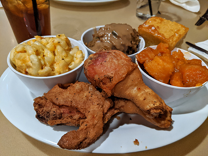 Soul food perfection on a plate. That golden-brown chicken practically whispers "I was worth the trip" with every juicy, perfectly seasoned bite.
