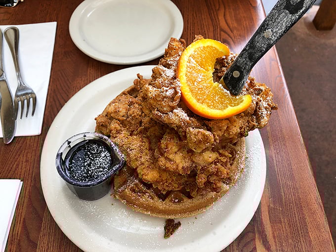 The legendary chicken and waffle tower—architectural wonder meets flavor explosion. That knife standing triumphantly says, "Yes, you'll need tools for this adventure."