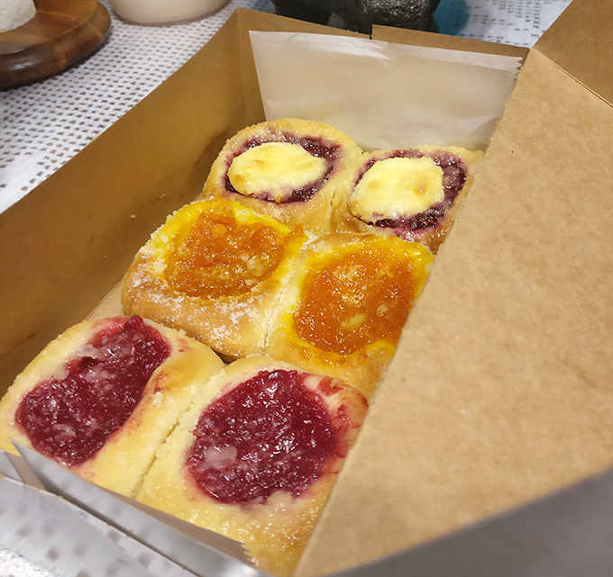 A box of fruit kolaches is like Texas sunshine in pastry form – bright berry and apricot centers nestled in golden dough.