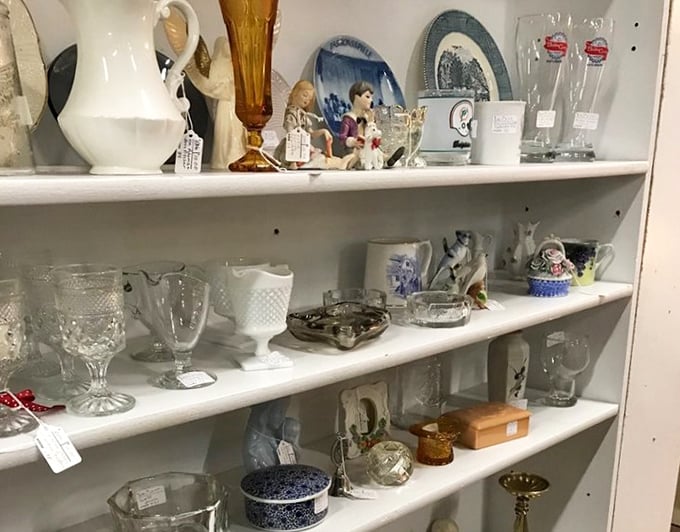 Delicate glassware catches the light like diamonds on these shelves. Each piece whispers stories of dinner parties and special occasions from decades past.