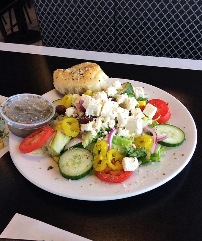 A vibrant Mediterranean vacation on a plate—crisp vegetables, briny olives, and feta cheese crumbles that somehow make eating healthy feel like cheating on your diet.