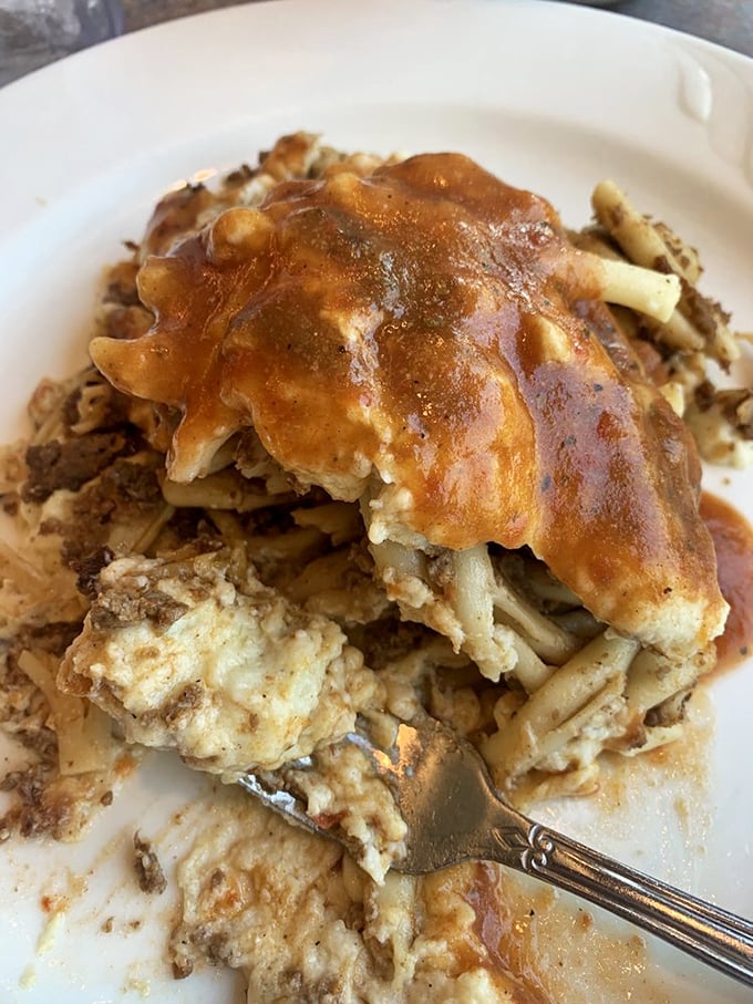 Comfort food architecture at its finest—layers of pasta, meat, and cheese under a blanket of sauce that says "today's diet starts tomorrow."