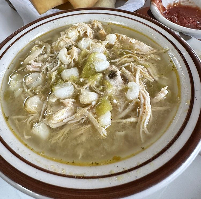 The Green Chili Posole arrives like a savory swimming pool of comfort – tender chicken, hominy, and green chiles dancing in harmony in every spoonful.