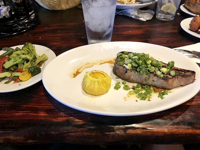 A perfectly seared tuna steak that's dressed for success with green onions and a corn husk boat of butter—seafood fashion at its finest.