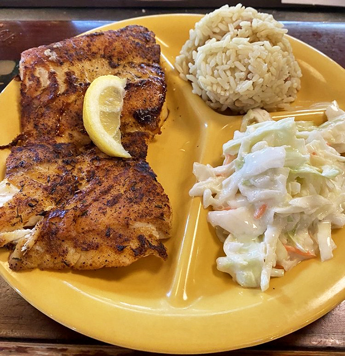 Blackened grouper that's wearing its spices like a well-earned suntan. That rice and slaw aren't just sides – they're supporting actors deserving their own applause.