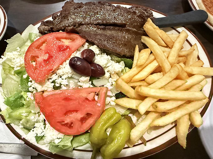The Greek salad and gyro plate—where Mediterranean dreams meet American portions. Those feta crumbles are practically a meal themselves!