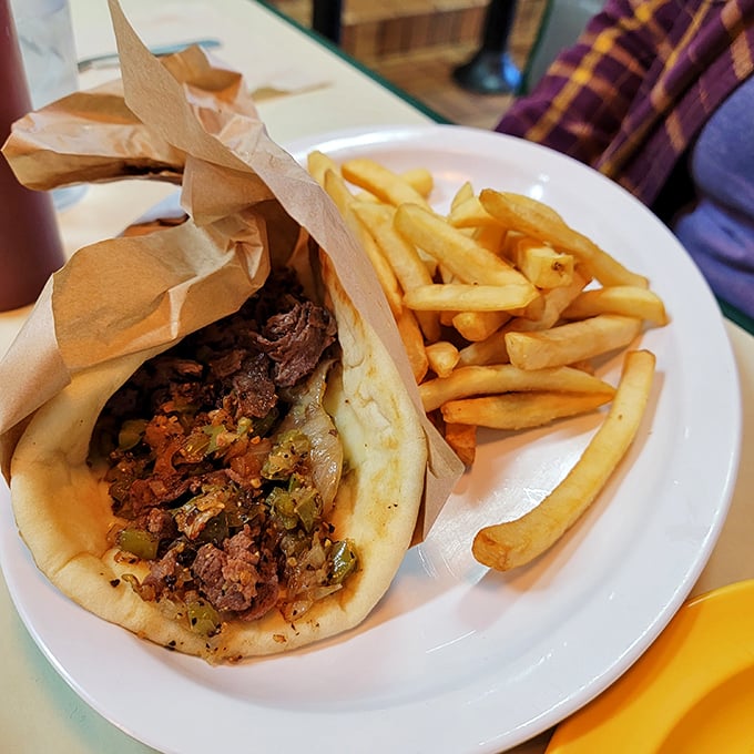 This isn't just a gyro—it's a Mediterranean hug wrapped in warm pita, with fries standing at attention nearby.