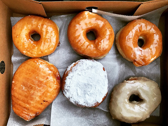 The donut box—California's most beloved six-pack. Each one a different personality, like the cast of your favorite sitcom. 