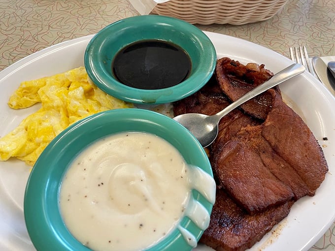 Country ham steak with red-eye gravy and creamy grits—a Southern breakfast trinity that could convert even the most devoted health food enthusiast.