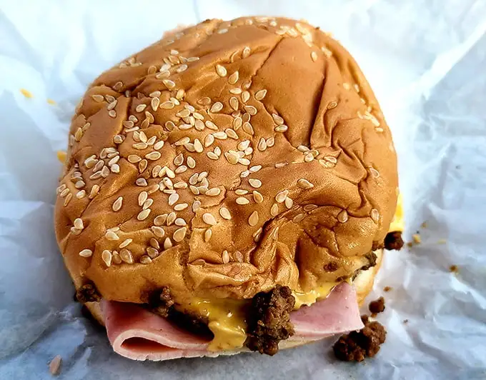 That sesame seed bun cradles ham and cheese like a edible love letter to your taste buds.