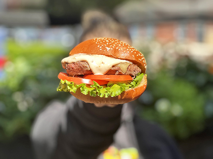 This burger means business – the kind of handheld happiness that makes you forget your table manners completely.